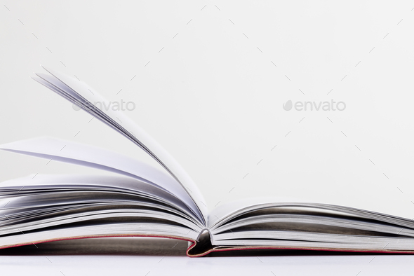 Image of open book lying on white background Stock Photo by Wavebreakmedia