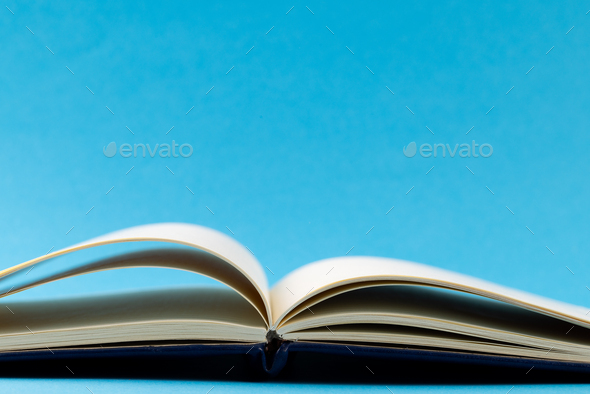 Image of open book with navy blue cover on blue background Stock Photo ...
