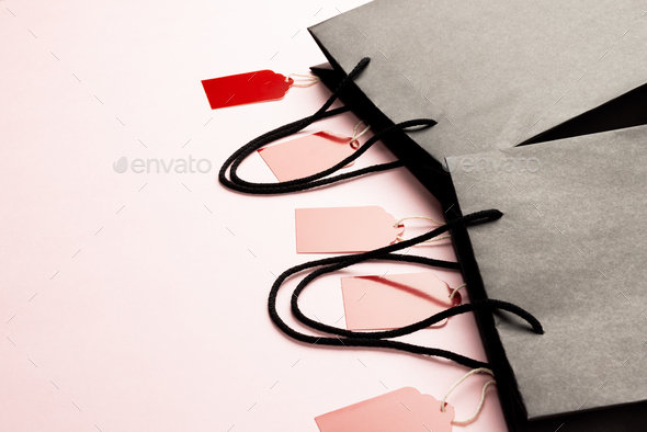 Composition of gift tags and bags with copy space on white background ...