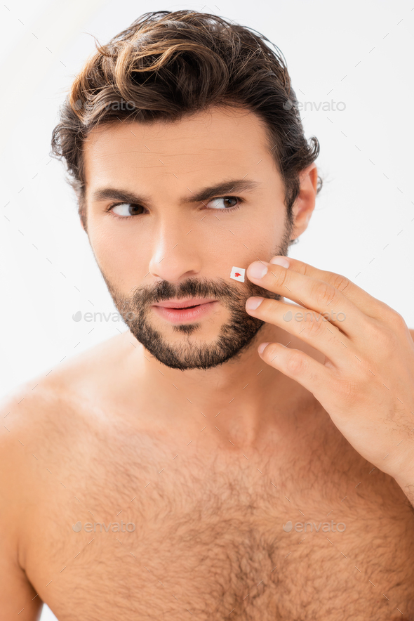 Shirtless man touching cheek with wound isolated on grey Stock Photo by ...