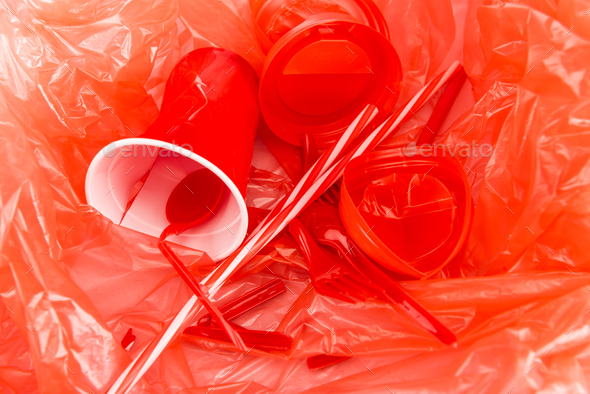 red disposable objects on plastic crumpled texture Stock Photo by ...