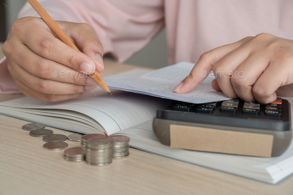 Woman doing home accounting calculating book bank statement for ...