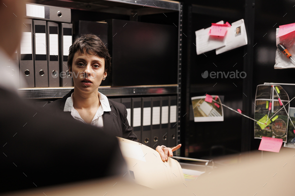 Police officer discussing missing person case with detective Stock ...