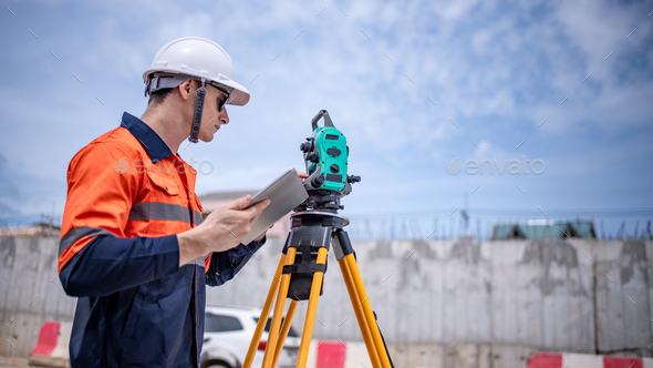 Engineers Surveyor wearing safety uniform ,helmet with equipment ...