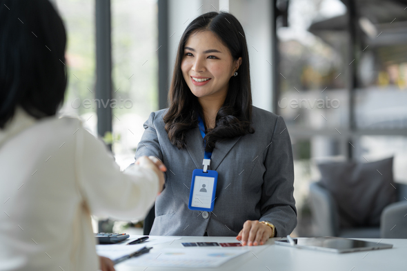 Young businesswoman, company worker shaking hands congratulating ...