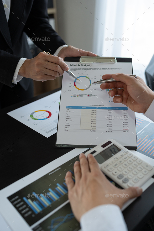 Business team analyzing income charts and graphs with laptop computers ...