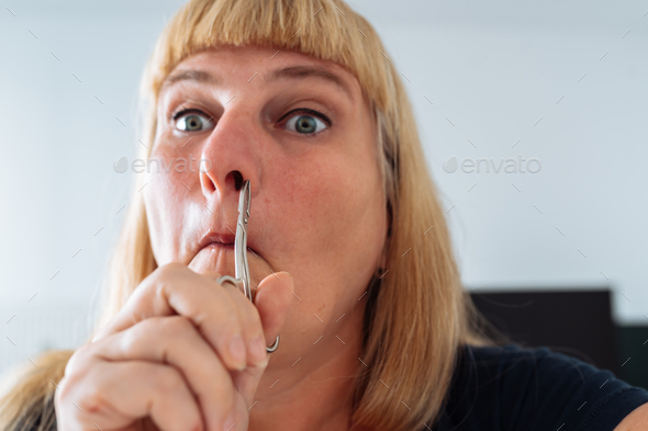 portrait woman plucking facial hair with tweezers Stock Photo by ...