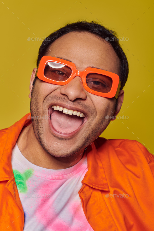 self-expression concept, excited indian man in orange sunglasses ...