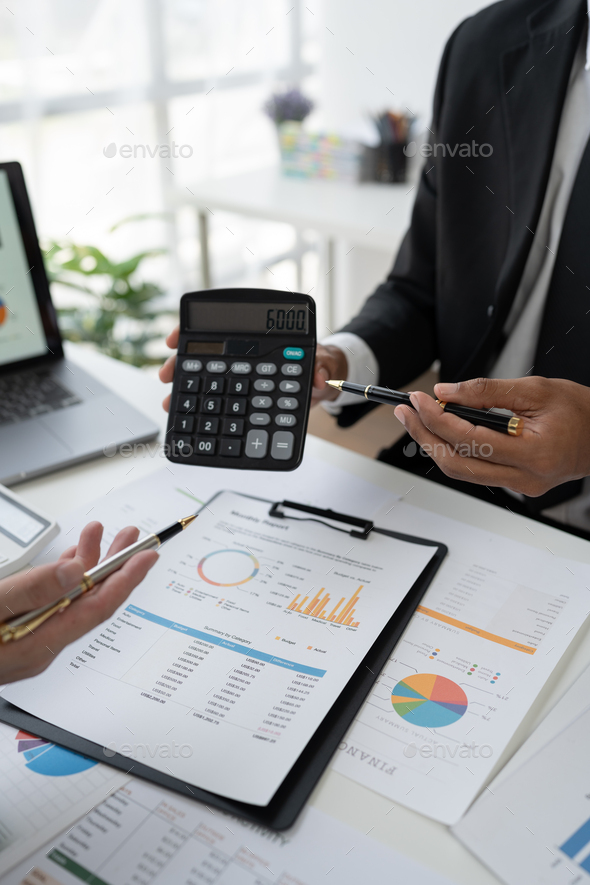 team work process Business team use calculator to calculate figures ...