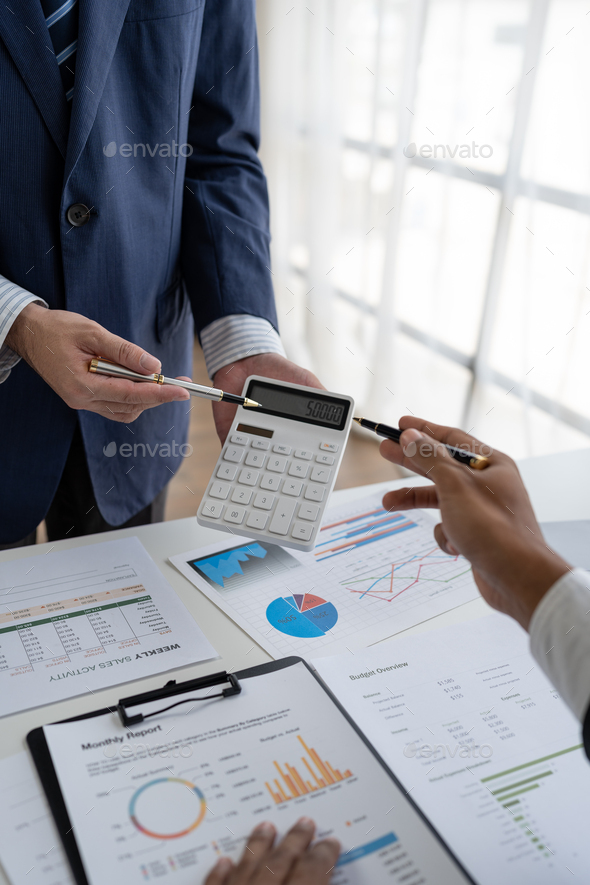 Financial analyst analyzing business financial report on laptop and ...