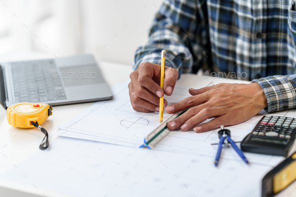 Architect engineer drawing plan blueprint of condominium or apartment ...
