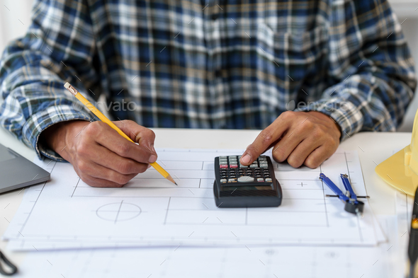 Architect engineer drawing plan blueprint of condominium or apartment ...