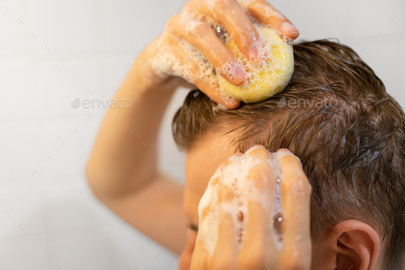 A man uses a solid shampoo bar in the bathroom. Sustainable hair care ...