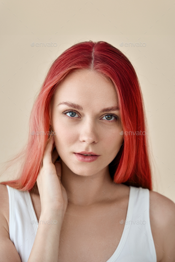 Young adult woman beauty female red hair model at beige background ...