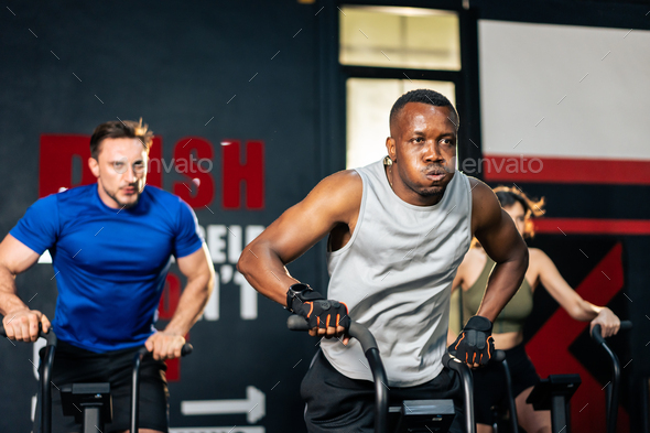 Group of young athlete people doing exercise together in fitness gym ...