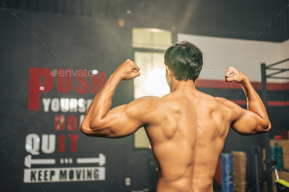 Asian active sportsman showing muscles and take calming deep breath ...