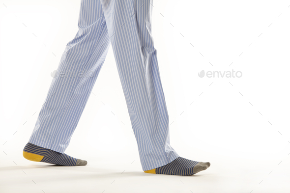 Man in pajama. Legs detail over a white background Stock Photo by ABBPhoto