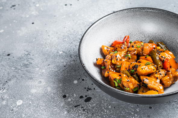 Chinese Sweet and Sour Pork guo bao rou in a bowl. Gray background. Top ...