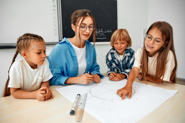 Children learning in a school classroom Stock Photo by ORION_production