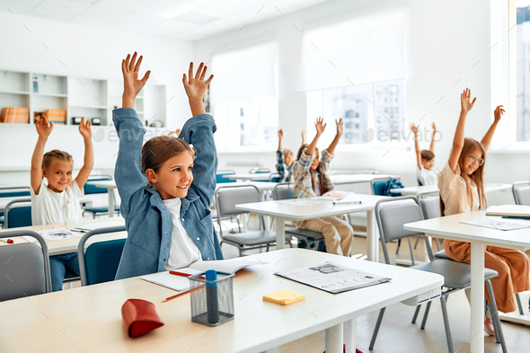 Children learning in a school classroom Stock Photo by ORION_production
