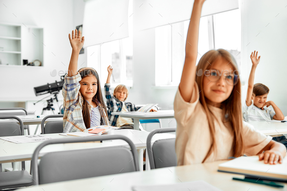 Children learning in a school classroom Stock Photo by ORION_production