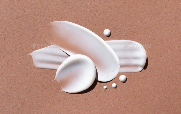 composition of smears of cream texture on a brown background Stock ...