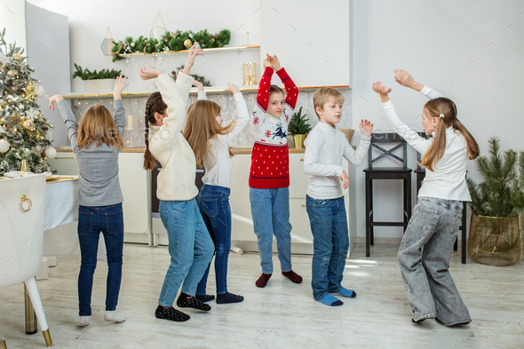Merry Christmas and Happy Holidays. Children having fun and dance at ...