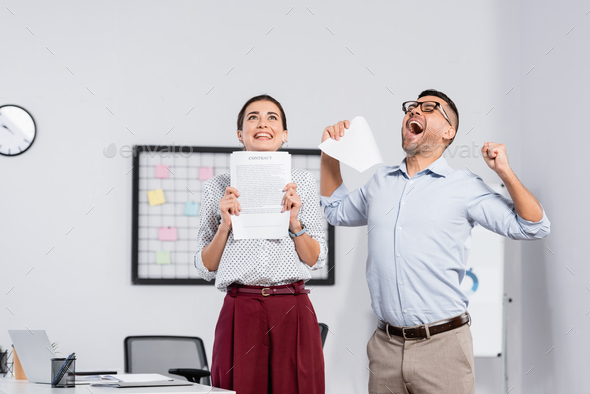 excited business people holding documents with contract in office Stock ...