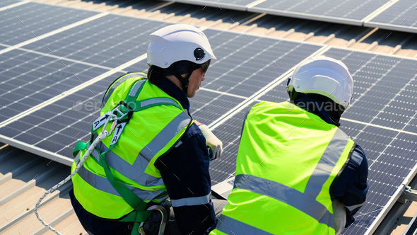 Engineers with safety helmet checking solar system at solar power farm ...