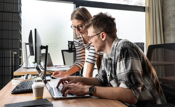 Programmers work alongside their colleagues in an office Stock Photo by ...