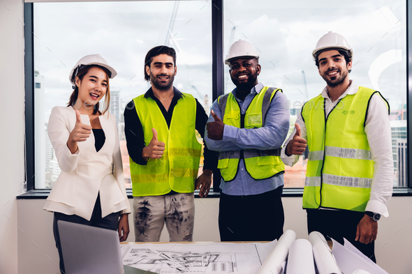 Team Engineers with draft plan of building on constructing site. Stock ...