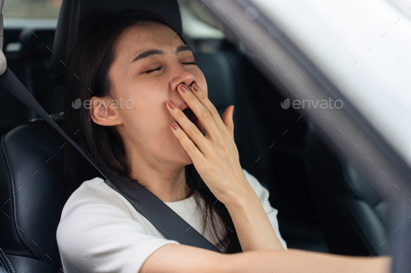 Asian beautiful woman yawned and fall asleep while driving in a car ...