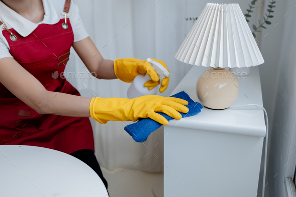 Asian woman cleaning staff, housekeeper cleaning tables in a company office, maintaining ...