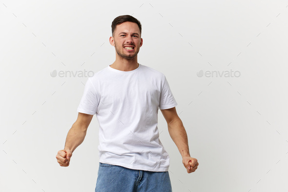 Screaming aggressive angry evil tanned handsome man in basic t-shirt ...