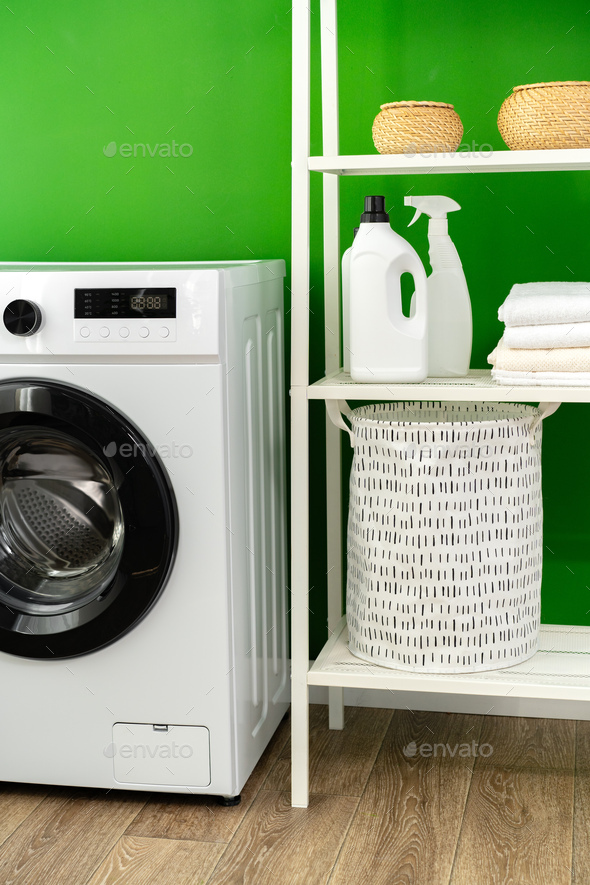 Modern white washing machine in a laundry room Stock Photo by FabrikaPhoto