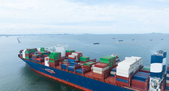 Aerial side view of cargo container ship carrying container from custom ...