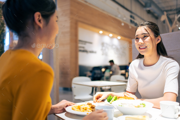 Asian beautiful women having dinner with friend in restaurant together ...