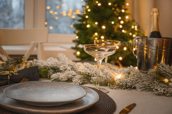 Christmas festive table setting, gold decorate and champagne. Family ...