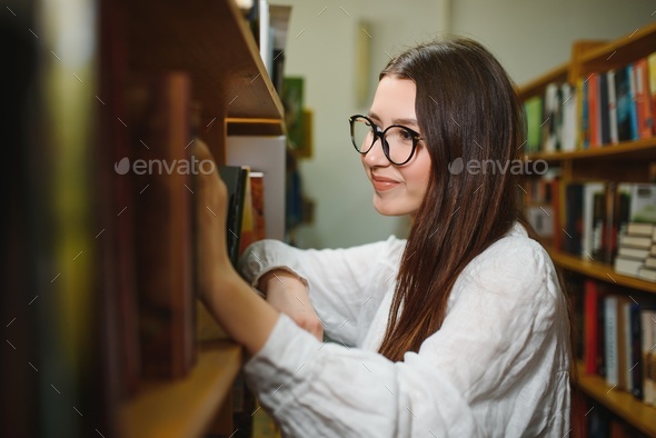 Portrait of a student girl studying at library Stock Photo by sedrik2007