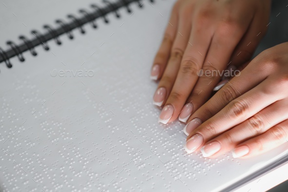 Blind woman read book written in Braille. Close up finger touch to ...