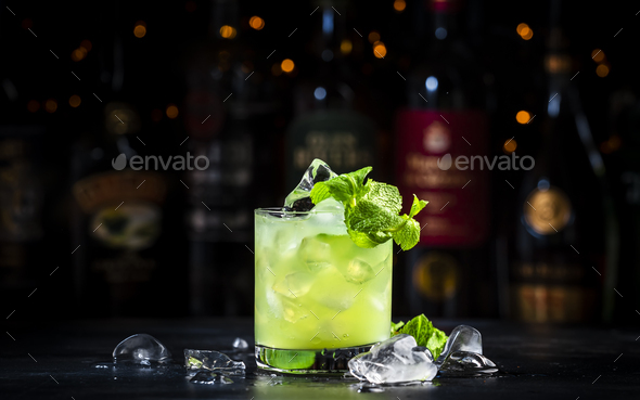 Green Negroni cocktail drink with dry gin, aperitif, gentian liqueur ...