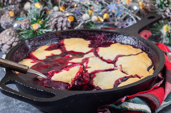 Homemade berry cobbler in cast iron skillet, Christmas decoration with ...