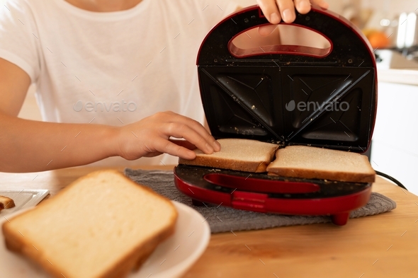 women's hands make toast in a toaster Stock Photo by traimakivan ...