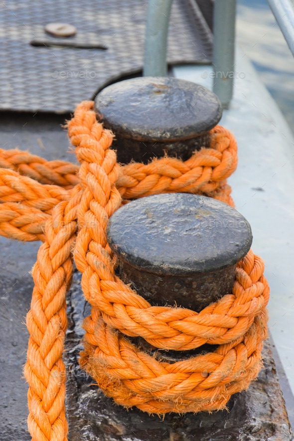 Thick rope and black mooring bollard. Detail of port. Yachting Stock ...