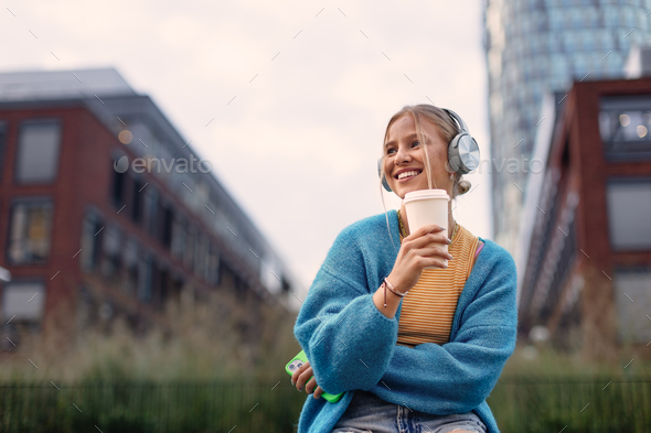 Portrait of stylish generation z girl student outdoors in the city ...