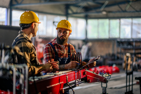 Mechanics brainstorming ideas while fixing electric machine together ...