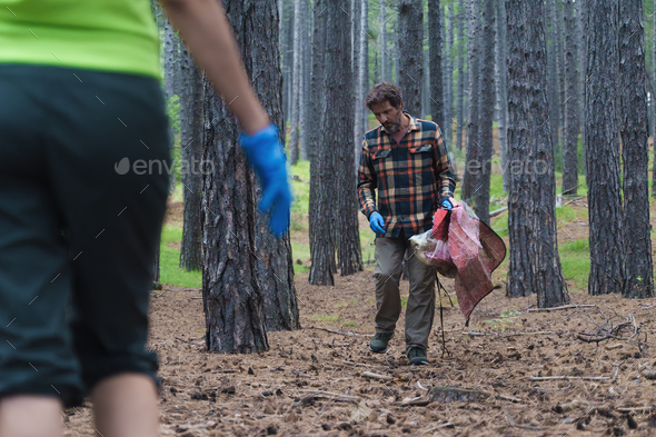 Man Cleaning Up Trash in Forest Stock Photo by baffos | PhotoDune