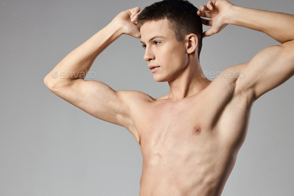 the guy holds his hands behind his head Sport Fitness pumped up muscles ...