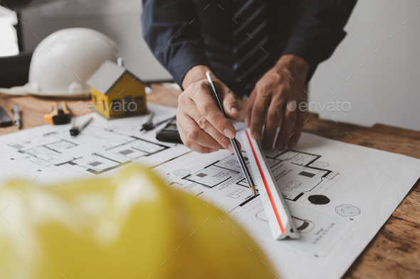 Architects design house plans for clients, drawing plans according to ...