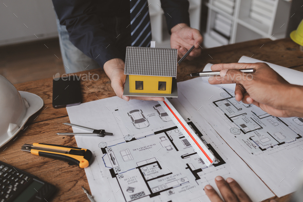 The home design architects are reviewing the house plan draft, the ...